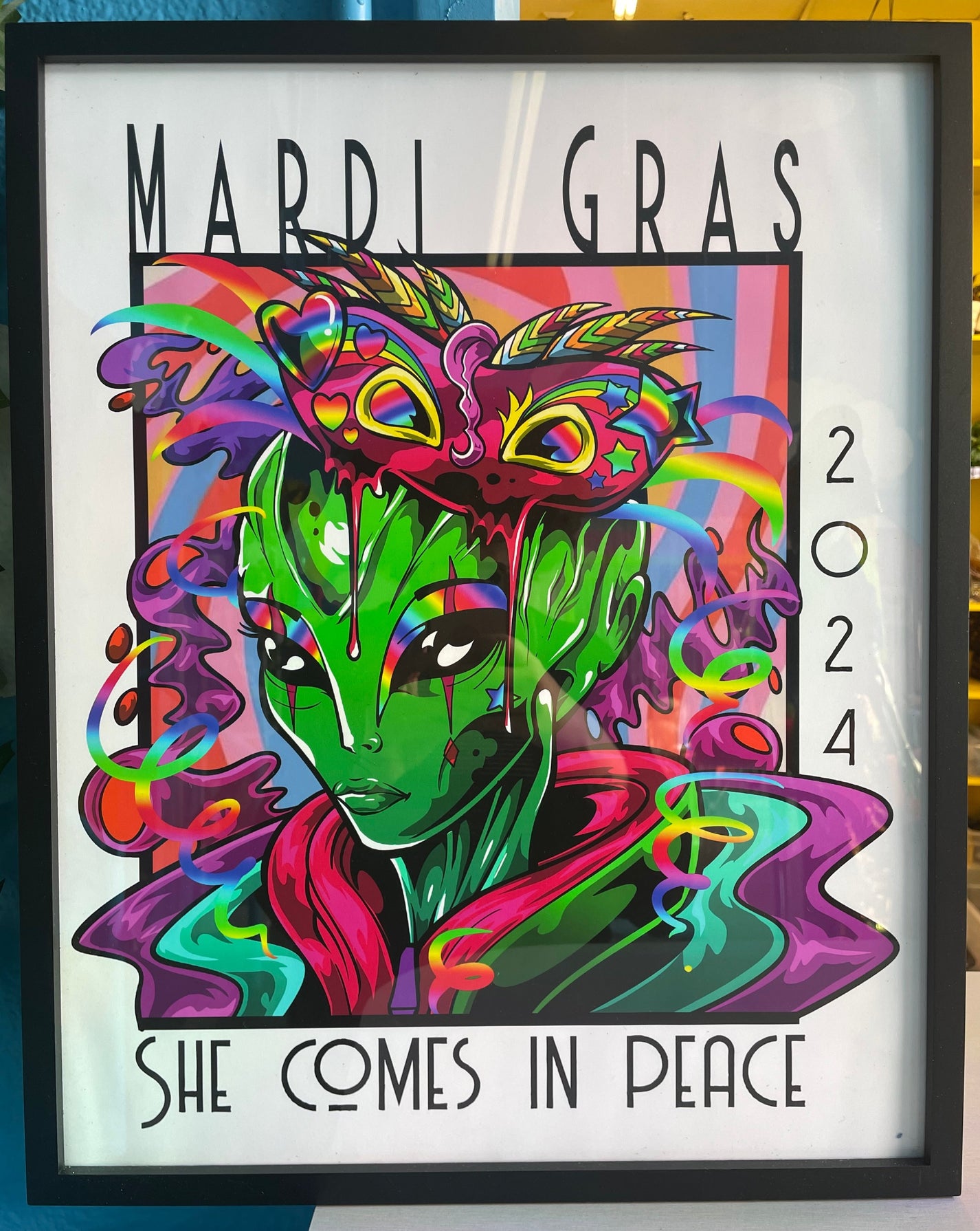 Mardi Gras 2024 Poster – She Comes in Peace